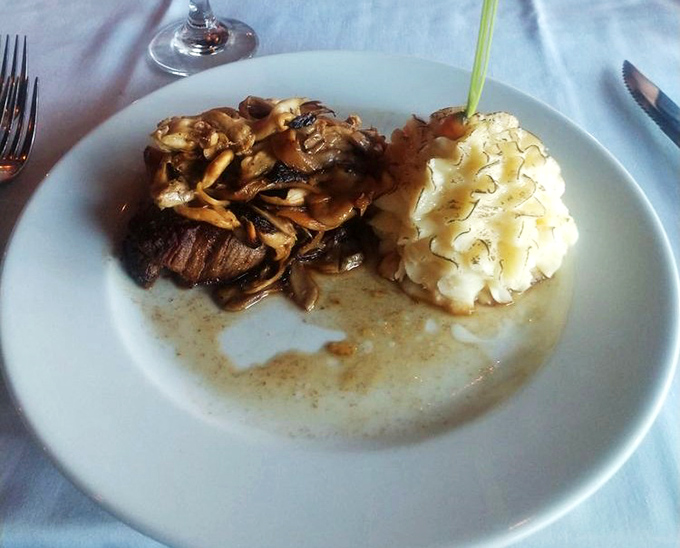 Steak perfection achieved: a tender filet paired with wild mushrooms and truffle potato pur&eacute;e. This plate doesn't just whisper "special occasion"&mdash;it announces it with authority.