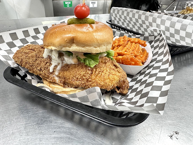 The legendary fish sandwich in all its glory—crispy, golden perfection with fresh toppings and a side that makes fries feel special again.