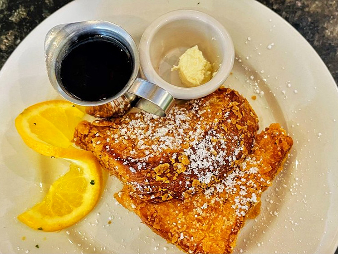 Behold the French toast that launched a thousand brunch pilgrimages. Crispy exterior, custardy interior, and that dusting of powdered sugar? Chef's kiss! 