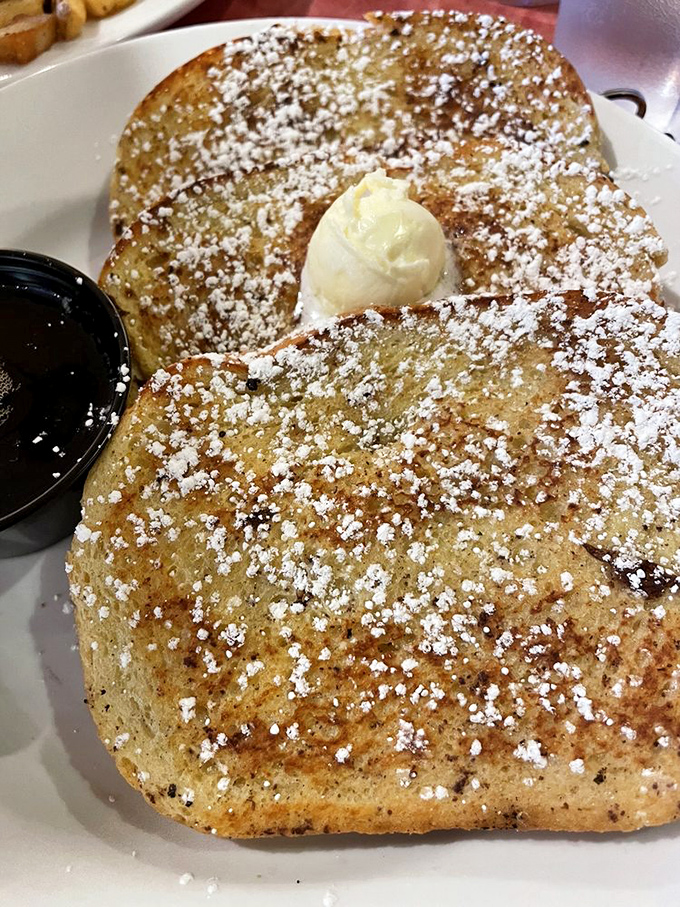 Golden-brown perfection dusted with powdered sugar and crowned with a dollop of butter &ndash; this French toast isn't just breakfast, it's morning therapy.