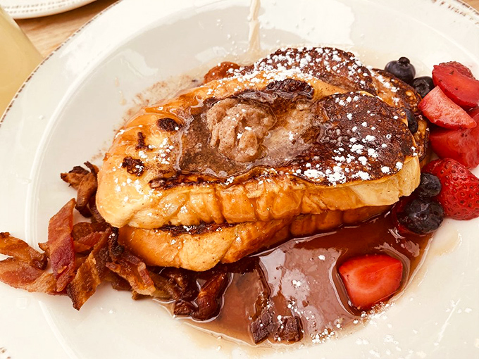 The French toast that launched a thousand return visits. This golden masterpiece demands a moment of silence before digging in.