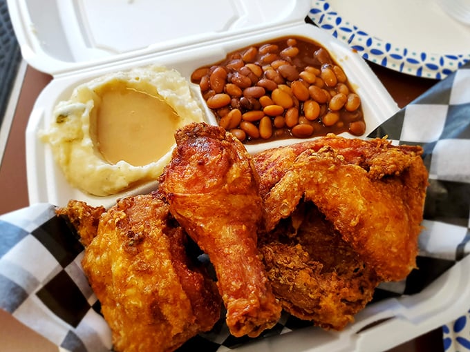 Golden-brown chicken with that perfect crackly skin, served alongside creamy mashed potatoes and baked beans. This isn't just food&mdash;it's edible nostalgia.