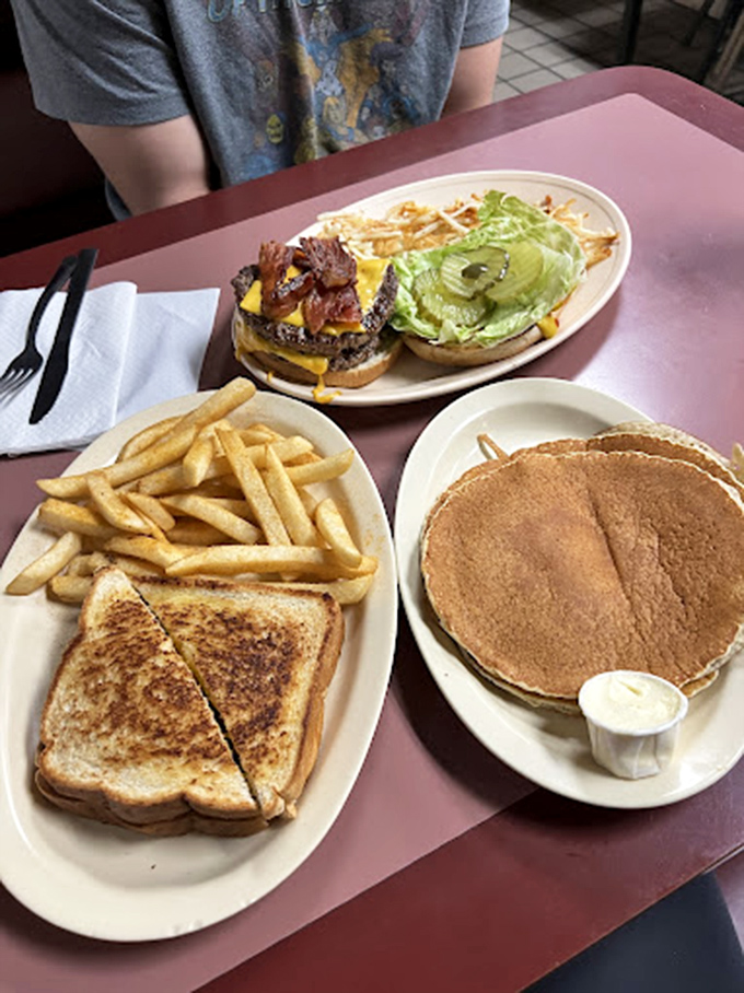 Diner perfection: That golden-brown grilled cheese with crispy fries, alongside pancakes and a bacon cheeseburger&mdash;Herbie's Place in a single tray.