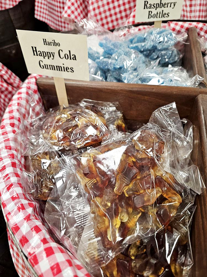 Haribo Happy Cola Gummies nestled next to Raspberry Bottles&mdash;proof that candy diplomacy transcends international borders in these wooden treasure chests.