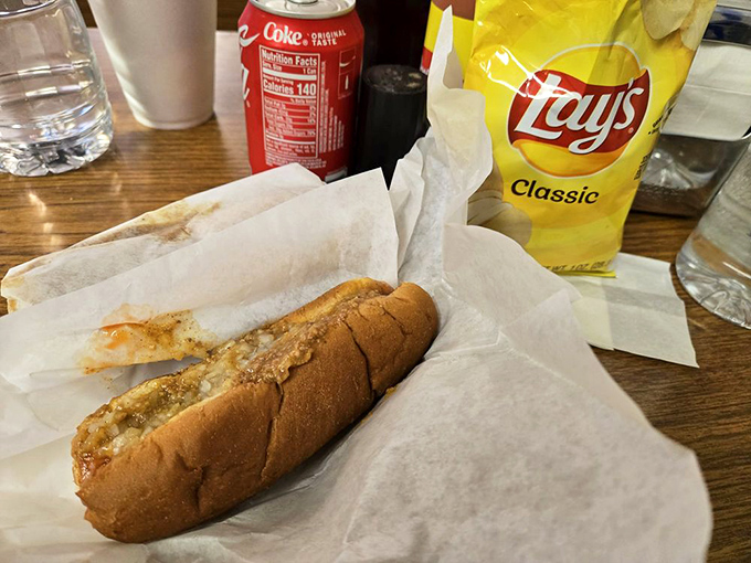 This isn't just lunch; it's a nostalgic masterpiece wrapped in paper. The hot dog and soda combo screams "American classic."