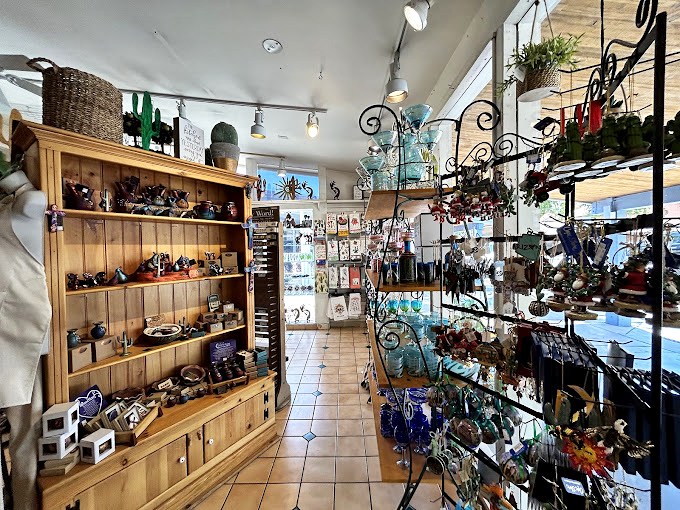 A wonderland of handcrafted treasures where ceramic cacti mingle with wooden birdhouses, proving that desert d&eacute;cor doesn't have to prick to make its point.