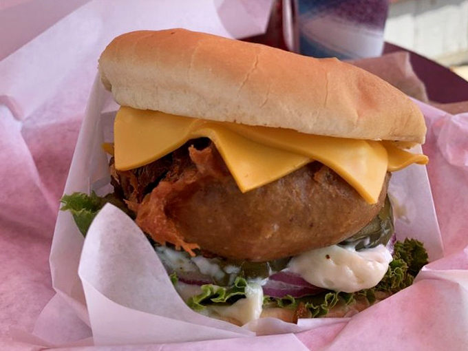 That perfect cross-section moment&mdash;juicy beef, melted cheese, and fresh veggies stacked between a golden bun. Poetry doesn't always rhyme; sometimes it's served with napkins. 