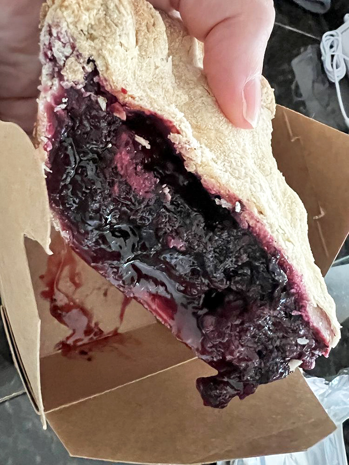 Berry nirvana in pie form. This slice of marionberry magic showcases Oregon's signature berry in all its deep purple glory.