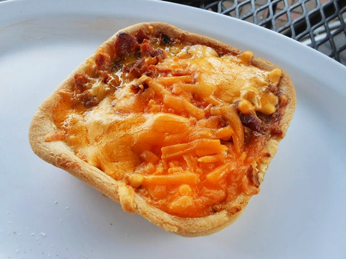 Behold the crown jewel of Australian cuisine! This meat pie's golden-orange cheese topping is melted to perfection, making resistance absolutely futile.