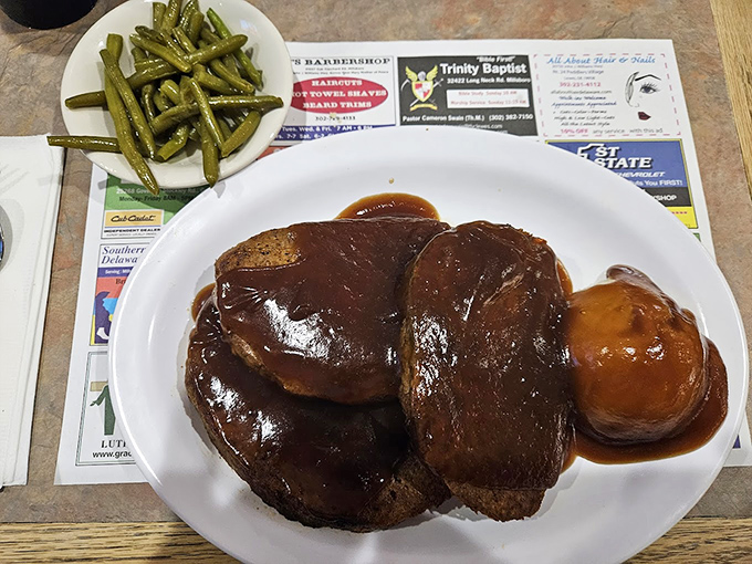 Behold the meatloaf that launched a thousand return visits! Glistening with gravy and flanked by green beans, it's comfort food elevated to an art form.