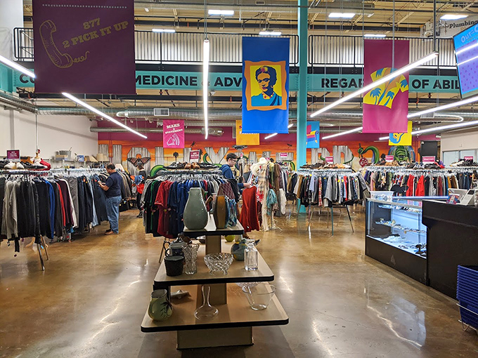 A rainbow of possibilities hangs from racks beneath colorful banners, proving that sustainable fashion doesn't mean sacrificing style or personality. 