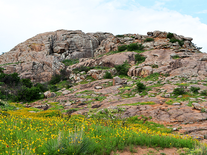 Oklahoma's ancient granite sentinels stand watch. These Wichita Mountains formations have been perfecting their pose since before selfies were invented.