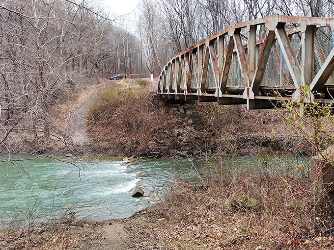 Winter transforms the landscape around Moonville into a serene wonderland. This bridge spanning the icy waters offers passage to adventurers brave enough to trek through snow.