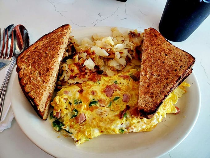 This isn't just breakfast&mdash;it's edible sunshine. Golden omelet meets perfectly crisped home fries with toast standing by for yolk-soaking duty.