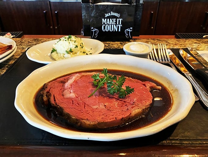 Behold the star attraction: prime rib presented in its ruby-red glory, resting in a pool of savory jus that's practically begging for a crusty roll dunk.