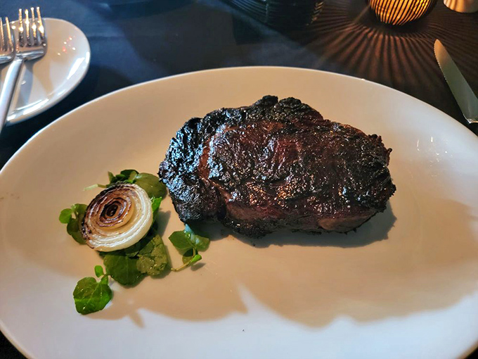 Behold the star of the show! This perfectly seared ribeye with its caramelized crust might just be what food dreams are made of.