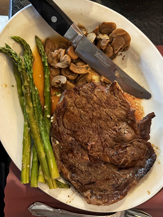Behold the steak whisperer's masterpiece: perfect char outside, rosy tenderness inside, with asparagus standing by for moral support. 