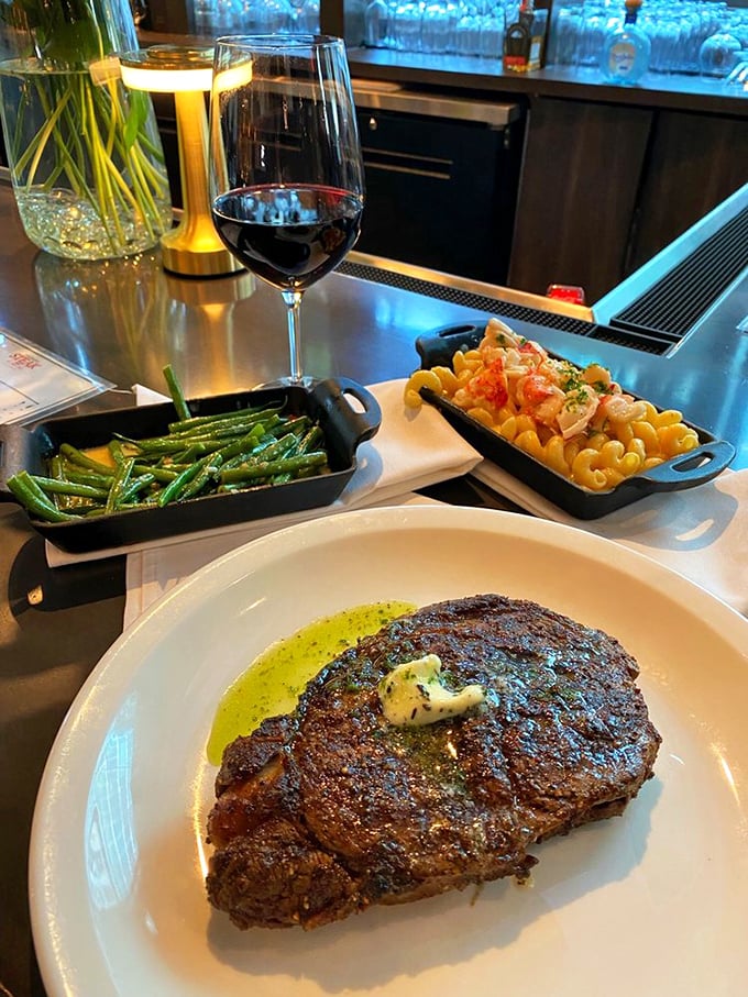 Behold the showstopper! A perfectly charred ribeye flanked by green beans and mac & cheese &ndash; the holy trinity of steakhouse satisfaction.