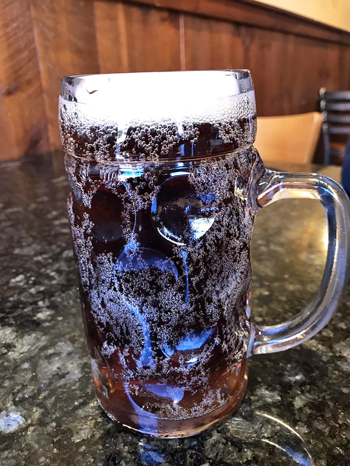 The legendary root beer arrives in a frosted mug that immediately develops ice crystals on the surface. It's not just a drink&mdash;it's a mountain town ritual in liquid form.