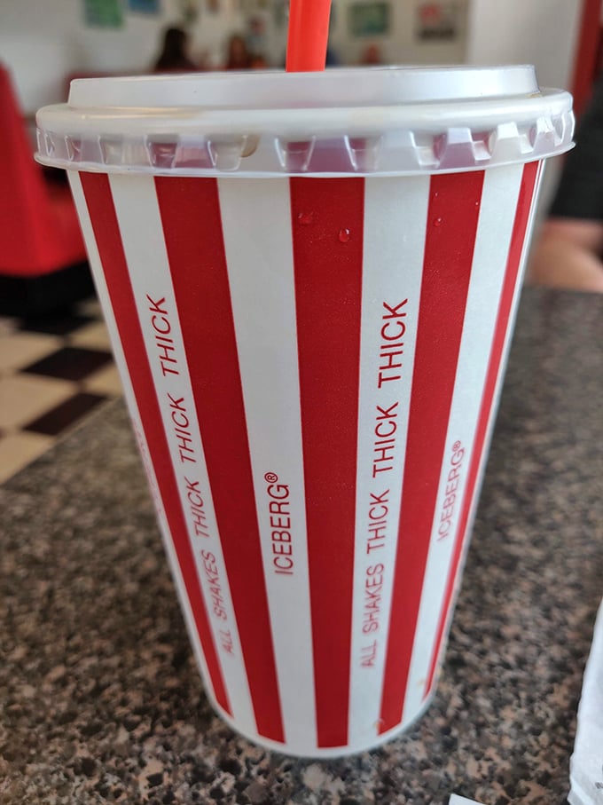 That striped cup isn't just holding root beer; it's cradling liquid nostalgia, served so cold the first sip might trigger brain freeze worth celebrating.