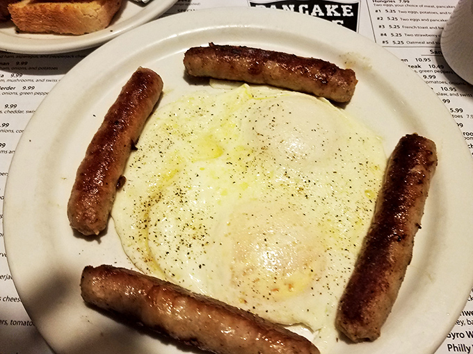 Sausage links standing guard around a perfectly cooked egg—breakfast's version of Stonehenge, but infinitely more delicious.