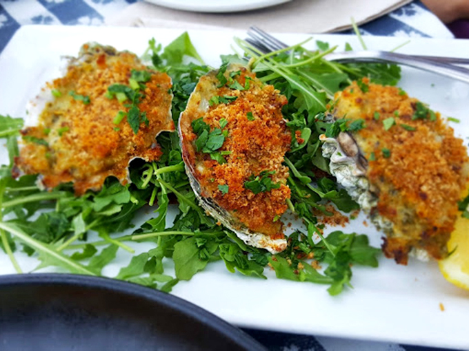 Golden-crusted treasures from the sea nestled on fresh greens. These oysters have dressed up for the occasion, and trust me&mdash;they clean up nice.