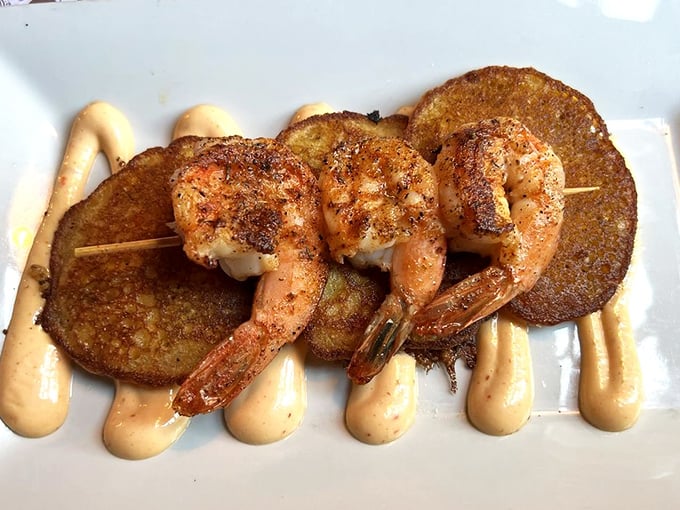 These blackened shrimp perched atop golden corn fritters aren't just appetizers&mdash;they're edible treasures that would make any pirate abandon their search for gold.