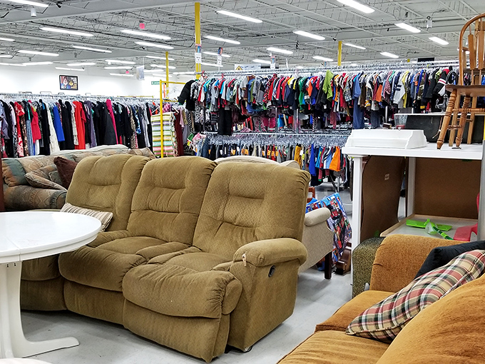 That tan reclining sofa has stories to tell, patiently waiting for its second act in someone's living room.