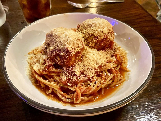 These meatballs don't just sit on the spaghetti; they reign over it like tasty monarchs in a kingdom of perfectly cooked pasta.