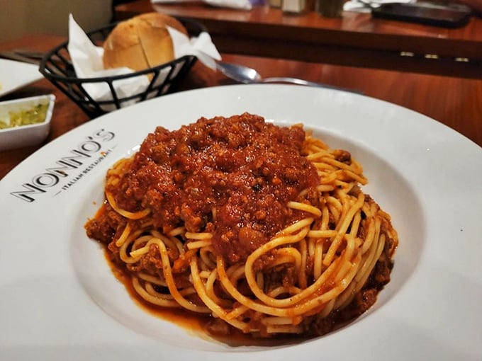 Spaghetti Bolognese that doesn't just sit on the plate &ndash; it performs. The sauce clings to each strand like it's afraid of being left behind.