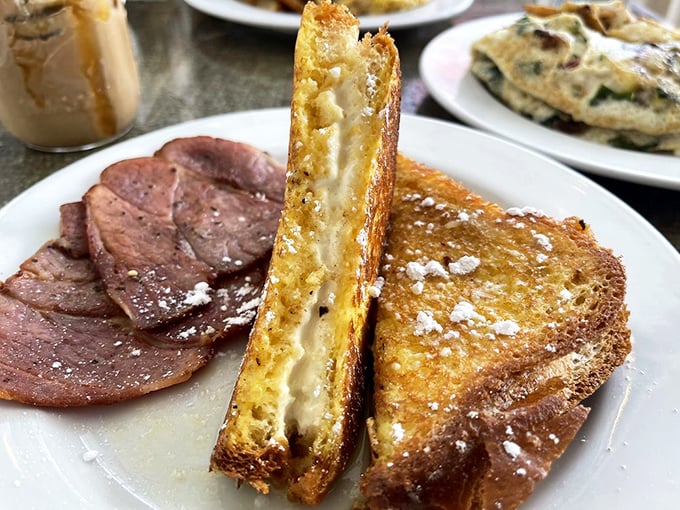 Behold the legendary Stuffed French Toast in its golden glory. That cream cheese filling is the breakfast equivalent of finding an extra $20 in your pocket.