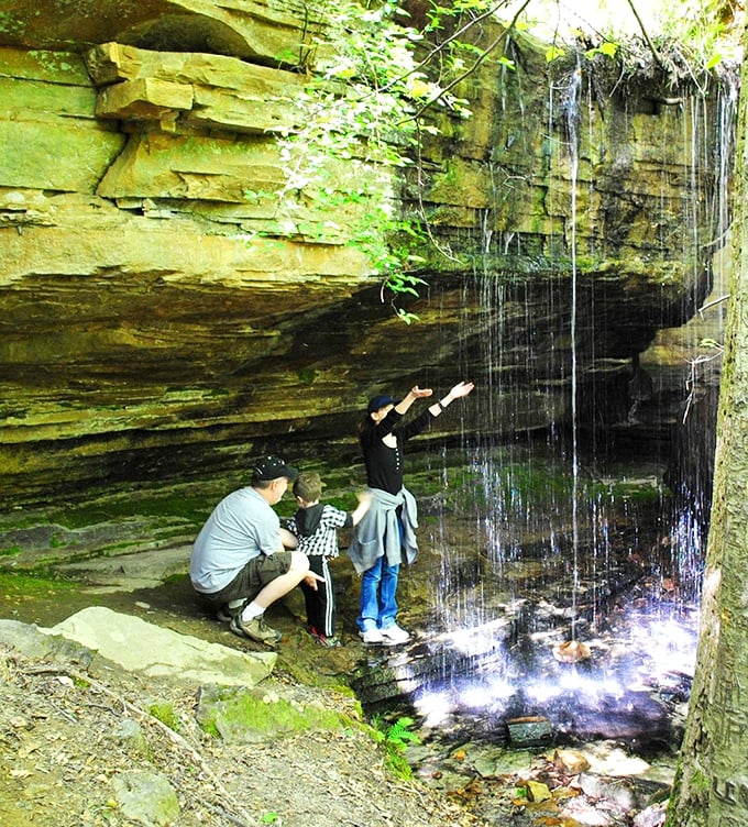The stone archway stands like a portal to adventure. This CCC-built entrance to the swinging bridge promises views worth every creaky step across. 