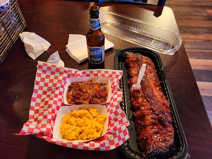 Behold, the rack of ribs that launched a thousand road trips. That bark! That glaze! That Blue Moon standing guard!