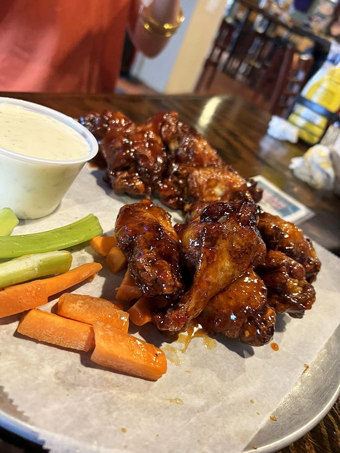 These wings aren't just food&mdash;they're an experience. The sauce glistens with promise while veggie companions stand by dutifully.