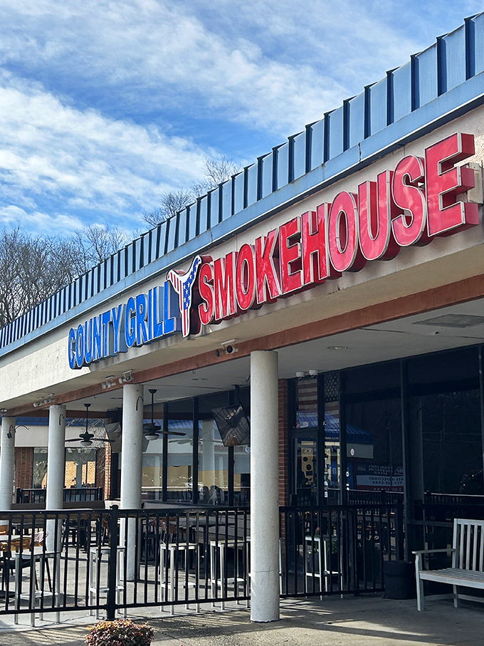 County Grill's bold sign promises smokehouse delights, while the packed patio confirms they deliver on that promise.