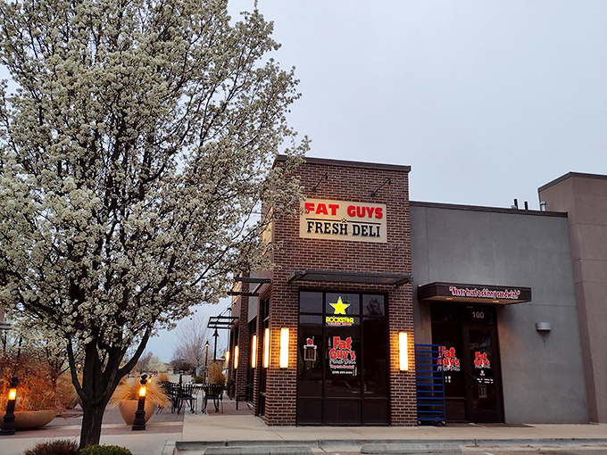 Fat Guys Fresh Deli glows with promise at dusk, like a sandwich lighthouse guiding hungry souls to safety.