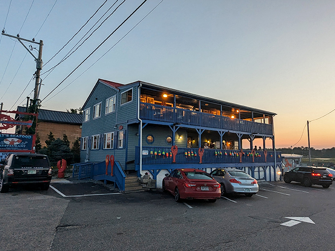Ray's blue exterior stands sentinel against the sunset, promising ocean treasures within its buoy-adorned walls.