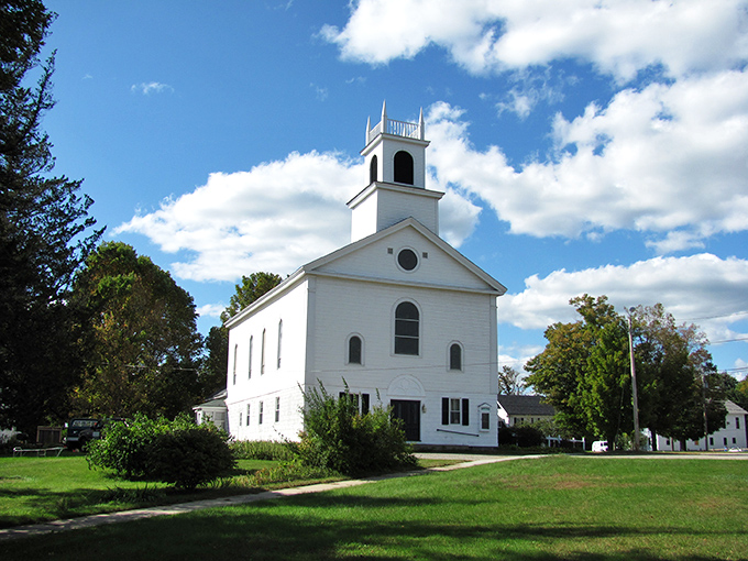 Swanzey's white church stands like a sentinel against time, watching over generations of Sunday best and potluck dinners.
