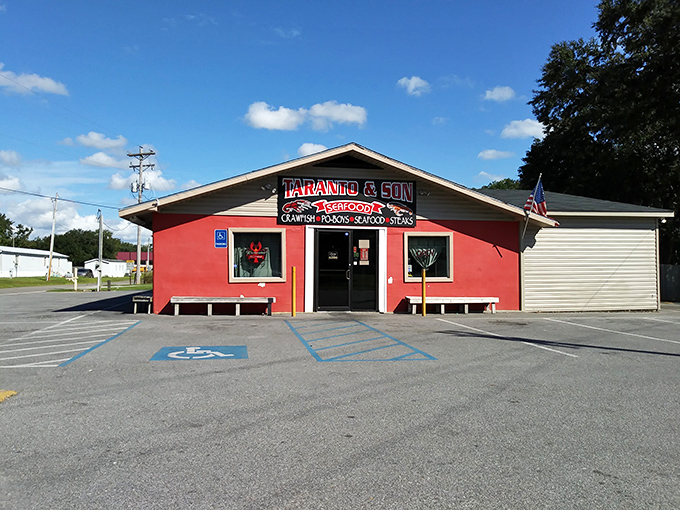 Taranto's bold red exterior stands out like a lighthouse for crawfish lovers - no frills, just thrills for your taste buds.