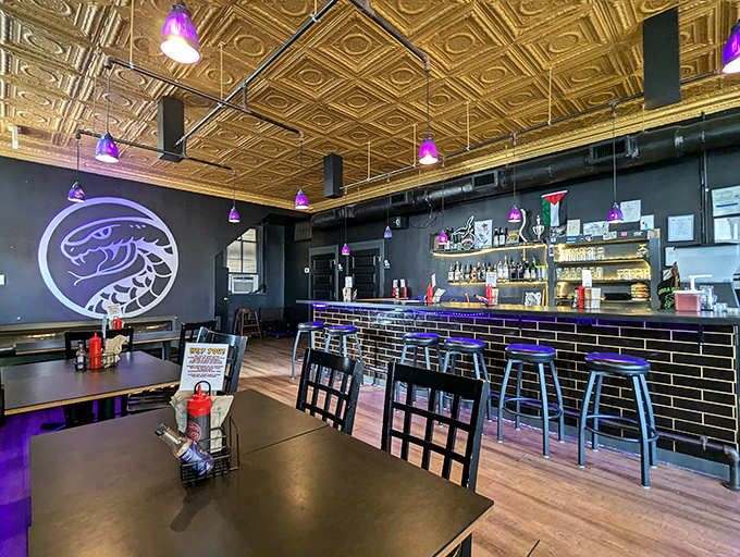 Stylish interior with moody lighting and gold ceiling tiles. Cobra's sleek design matches its sophisticated approach to the humble hamburger.