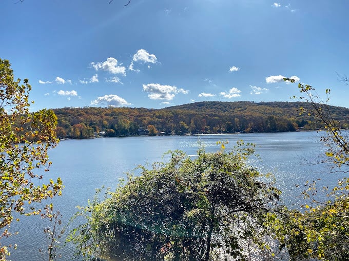 Fall foliage paints Wawayanda State Park in golden hues, with each tree perfectly mirrored in the still, lily-dotted waters below.