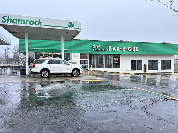 Rain-slicked pavement leading to Joe's Kansas City &ndash; a BBQ pilgrimage site worth braving any weather for.