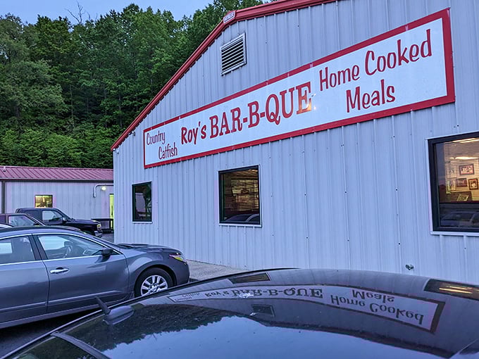 Roy's white building with red trim&mdash;like a Christmas present filled with smoky treasures. The reflection in the puddle perfectly captures BBQ daydreams!
