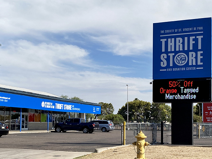 Morning light illuminates St. Vincent's sign, promising a day of discoveries. The early thrifter catches the vintage treasures.