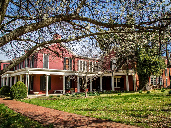 Spring blossoms frame this historic red brick beauty &ndash; Wakefield-Scearce Galleries brings Southern mansion vibes to your antique hunting adventures.