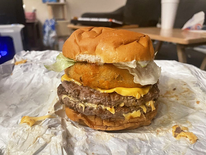 This isn't just a burger—it's edible architecture. The melty cheese cascading down those perfectly seared patties is what dreams are made of.