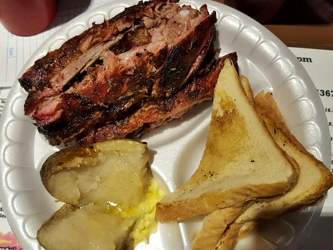 Barbecue architecture at its finest: sturdy ribs with that telltale pink smoke ring, paired with simple toast &ndash; because fancy bread would just be showing off.