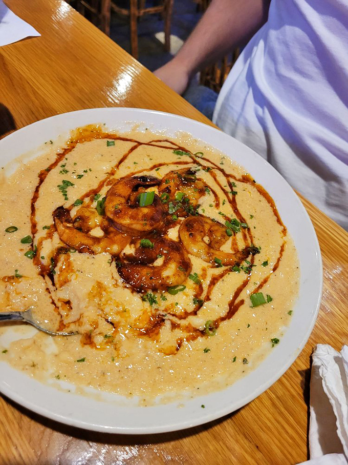 BBQ shrimp nestled on a creamy grits island, surrounded by a sea of savory sauce. The kind of dish that makes you consider licking the plate when no one's looking.