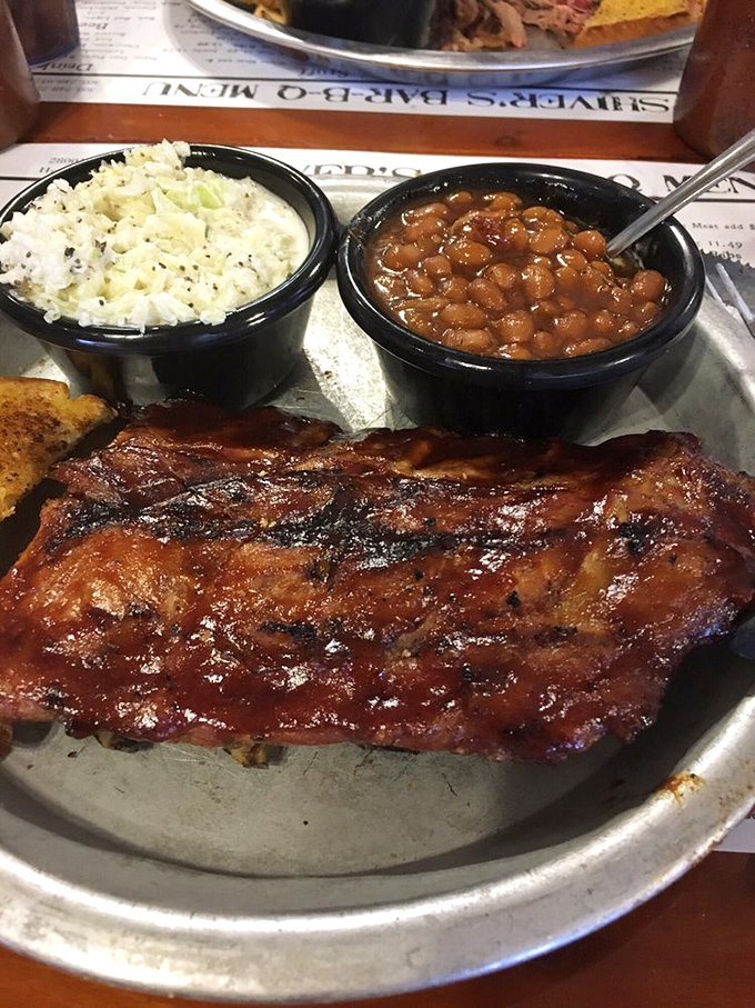 Baby back ribs with that perfect lacquered finish, flanked by creamy slaw and baked beans&mdash;the holy trinity of Southern comfort.