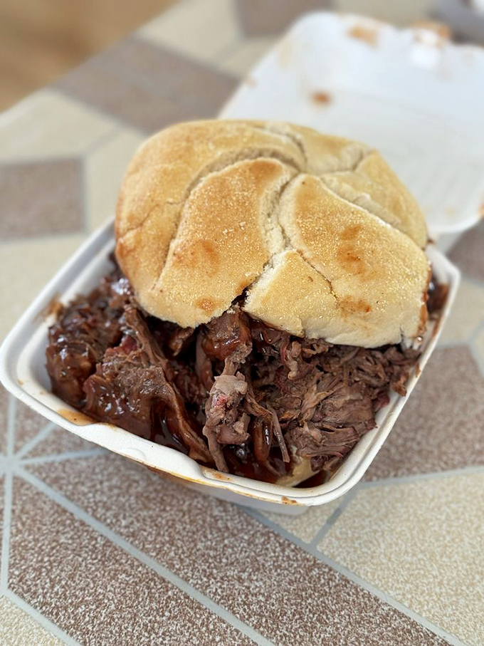 This isn't just a sandwich; it's an architectural marvel of smoked beef and bread that requires both hands and zero shame.